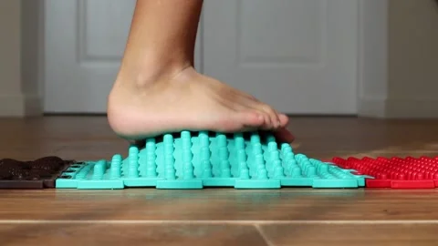 Children's feet stepping on multi-colore... | Stock Video | Pond5