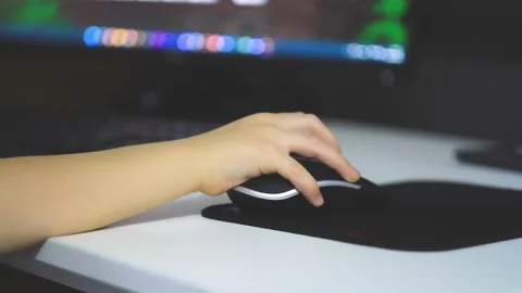 Child's hand controls computer mouse whi... | Stock Video | Pond5