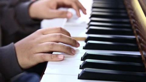 a child's hand holding a piano keyboard | Stock Video | Pond5