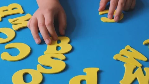 Child's hand playing with letters of the... | Stock Video | Pond5