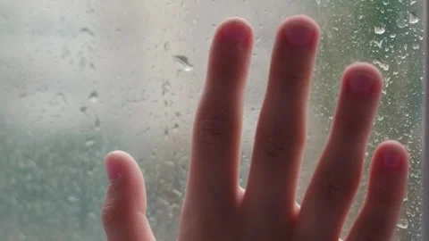 a child's hand on the window glass behin... | Stock Video | Pond5