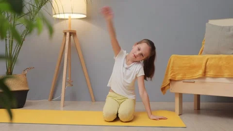 Child's home yoga. Kid's fitness routine... | Stock Video | Pond5