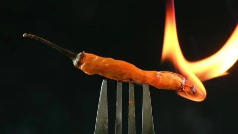 A chili pepper burning on fire and relea... | Stock Video | Pond5