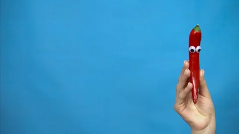 Chilli pepper with eyes in a woman hand.... | Stock Video | Pond5