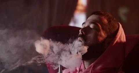 Chilling man with whiskey smoking hookah | Stock Video | Pond5