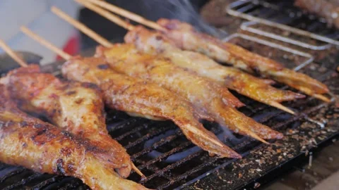 Chinese fried fish kebab barbecue on gri... | Stock Video | Pond5