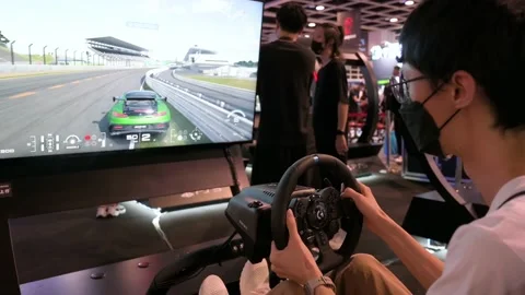 A Chinese gamer plays a themed racing vi... | Stock Video | Pond5