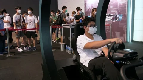 A Chinese gamer plays a themed racing vi... | Stock Video | Pond5