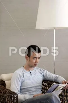 Chinese Man Sitting And Reading Magazine Beijing China Copyright ...