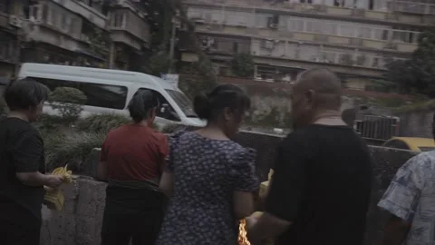Chinese people burn joss paper in their ... | Stock Video | Pond5
