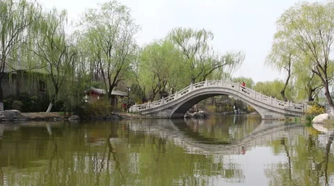 Chinese traditional arch bridge on lake | Stock Video | Pond5