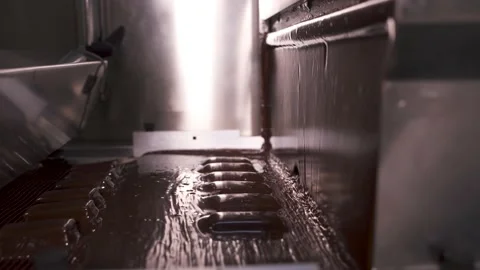 Chocolate Factory. A stream of hot melte... | Stock Video | Pond5