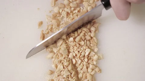 chopping roasted peanuts with a knife. w... | Stock Video | Pond5