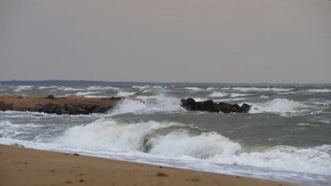 Choppy sea waves crash against rocky jet... | Stock Video | Pond5