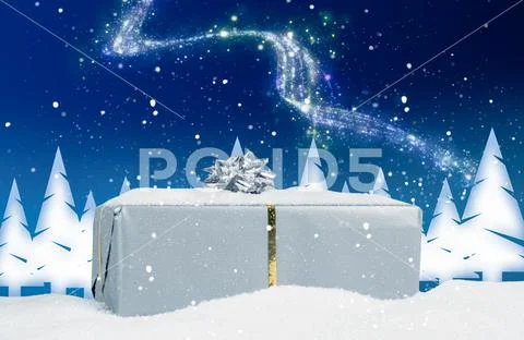 A Christmas present in front of wintry background Stock Image #142070826