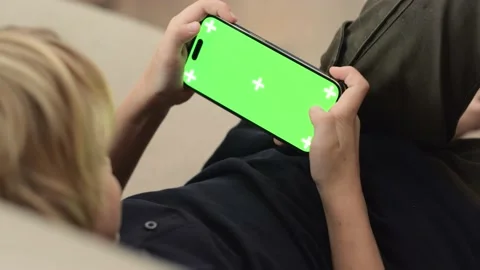 Chroma key green screen iPhone 14 in kid... | Stock Video | Pond5