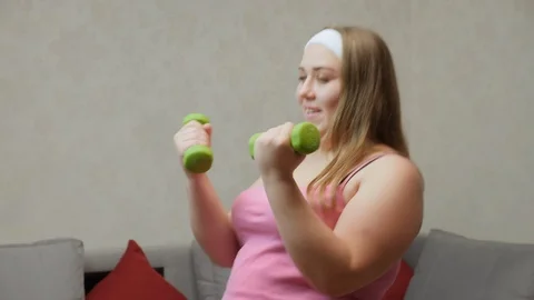 Chubby girl doing exercise by dumbbell i... | Stock Video | Pond5