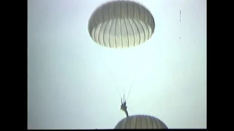 CIDG soldiers parachutes float down duri... | Stock Video | Pond5