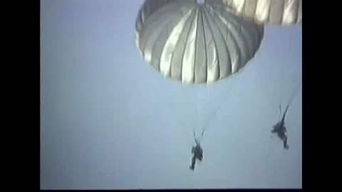 CIDG soldiers parachutes float down duri... | Stock Video | Pond5