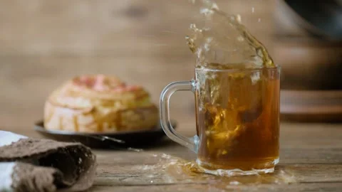 Cinemagraph - Сup of tea with bun on th... | Stock Video | Pond5