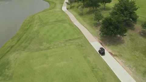 Cinematic Aerial: Golf Cart Driving Alon... | Stock Video | Pond5