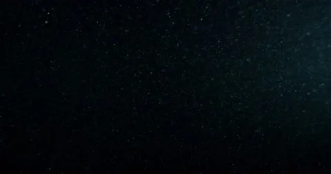 Cinematic dust particles floating on Bla... | Stock Video | Pond5