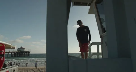 Cinematic shot of lifeguard walking to g... | Stock Video | Pond5
