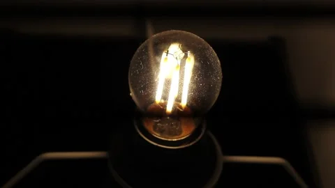 Classic light bulb lit up and screen fli... | Stock Video | Pond5