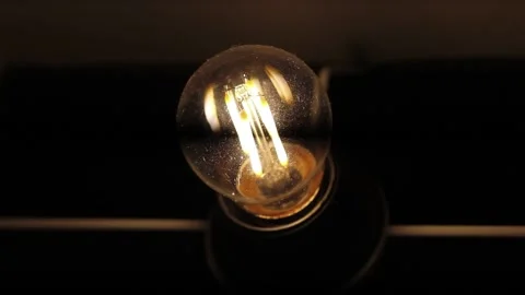 Classic light bulb lit up and screen fli... | Stock Video | Pond5