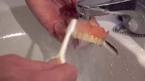 Cleaning and washing of the teeth dentur... | Stock Video | Pond5