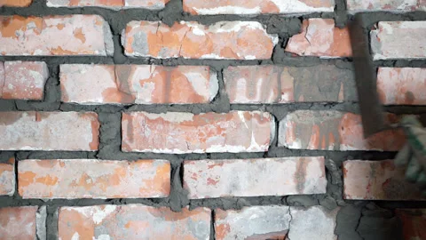 Cleaning bricks from cement mortar. | Stock Video | Pond5