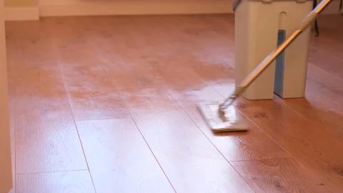 Cleaning the floor from dust using a han... | Stock Video | Pond5