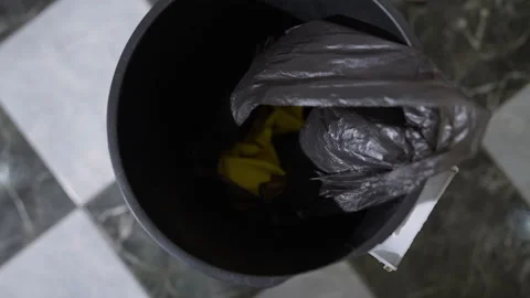 Cleaning supplies falling in garbage bag... | Stock Video | Pond5