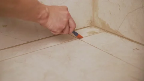 Cleaning tile joints on the floor. | Stock Video | Pond5