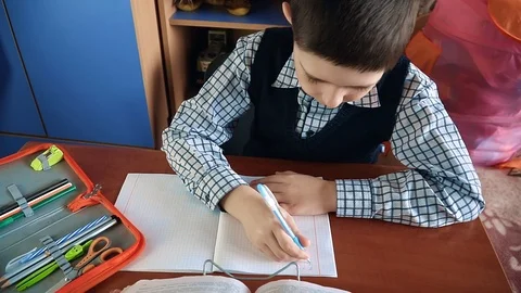 Clever boy write numbers and solve examp... | Stock Video | Pond5
