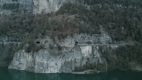 Cliff with human-made road tunnel, surro... | Stock Video | Pond5