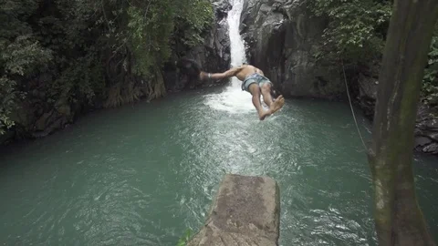 Cliff Jump Twisting Flip into Bali Water... | Stock Video | Pond5