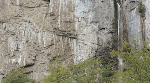 Climbers on big limestone wall waterfall | Stock Video | Pond5