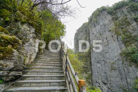 The climbing stone steps are located between two high mountain stone ...