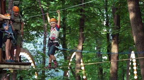 Climbing on trees, outdoor kids game. Ki... | Stock Video | Pond5