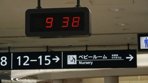 Clock and gate information sign at Narit... | Stock Video | Pond5