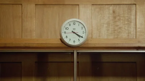 Clock hanging on the wall of a UK court ... | Stock Video | Pond5