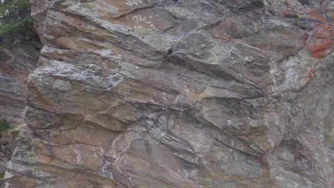 Close up aerial view of rock cliff face.... | Stock Video | Pond5