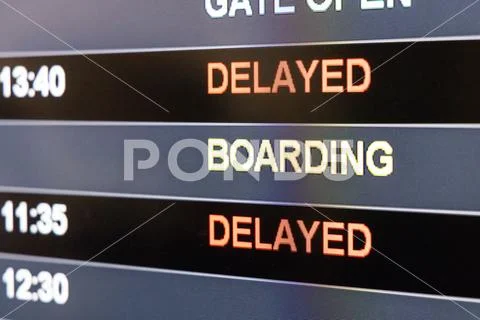 Close-up on airport flight information digital board with focus on the ...