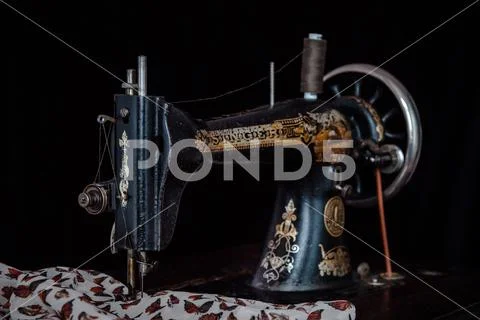 Photograph: Close up of antique sewing machine Singer on black ...