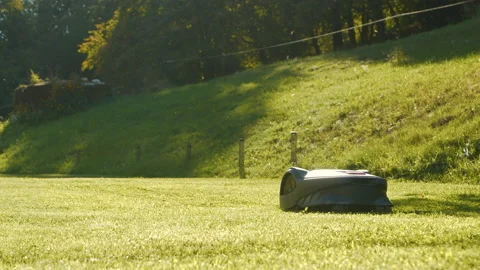 CLOSE UP: Autonomous robotic lawn mower ... | Stock Video | Pond5