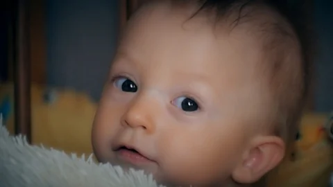 Close up of baby's face while it smiles ... | Stock Video | Pond5