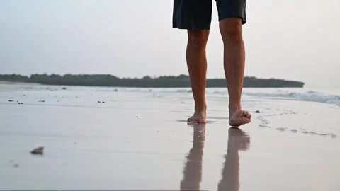 Close-up of the bare legs of a man walki... | Stock Video | Pond5