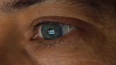Close up blue eye in front of a pc scree... | Stock Video | Pond5