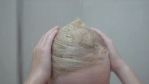 Close-up, a boy washes his white hair wi... | Stock Video | Pond5